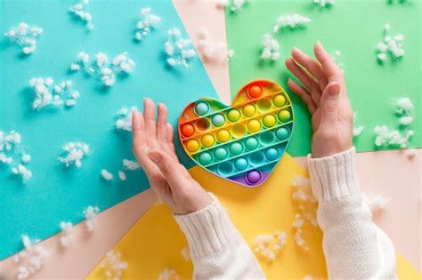 Premium Photo Female Hands Surround A Silicone Rainbow Antistress Toy