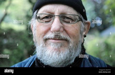 Portrait Of A 68 Year Old Senior Man Wearing Blue Clothes And A Black