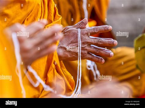 Buddhist Monk Hands Are Connected To The Bride And Groom By A String