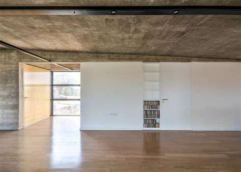 House By Tectum Features Raw Concrete Walls And Black Metal