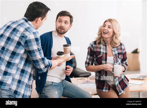 Nice Friendly Colleagues Having A Conversation Stock Photo Alamy