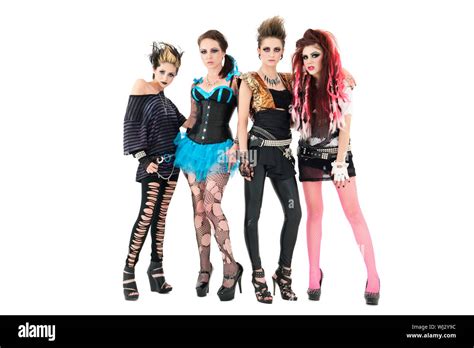 Portrait Of All Female Rock Band Posing Together Over White Background