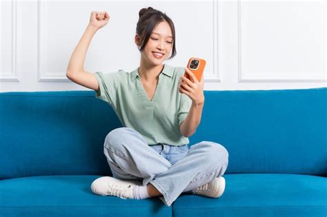 Premium Photo Image Of Young Asian Girl Sitting On Sofa At Home