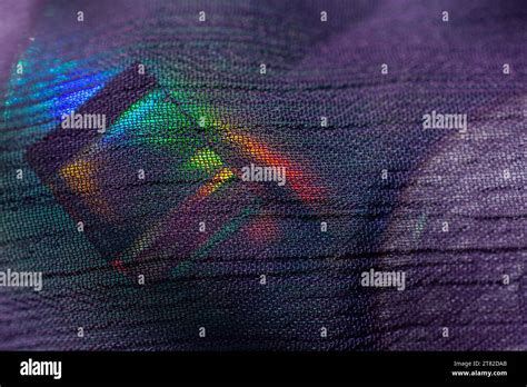 Glass Cube With Color Spectrum Rays On Fabric Abstract Background With Reflection And