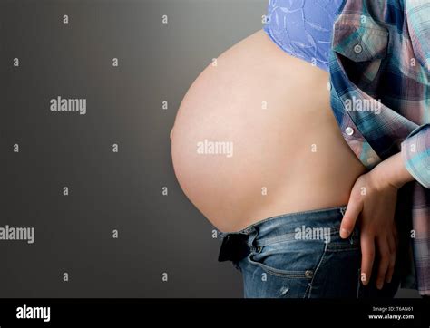 Pregnant woman caressing her belly Stock Photo - Alamy