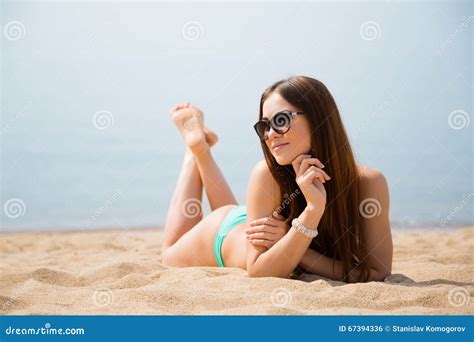Brunette Lying On A Sandy Beach Stock Photo Image Of Beauty
