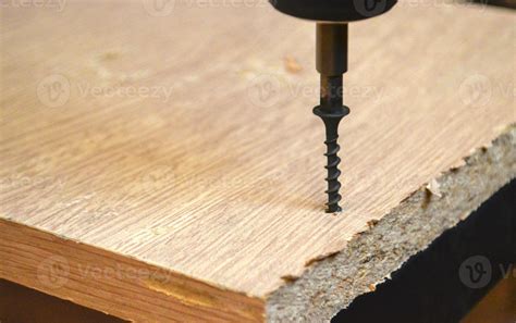 Drills A Hole In A Chipboard Drill Screwing A Screw 14609367 Stock