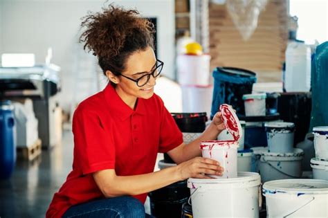 Premium Photo A Smiling Printing Shop Worker Choosing Colors While