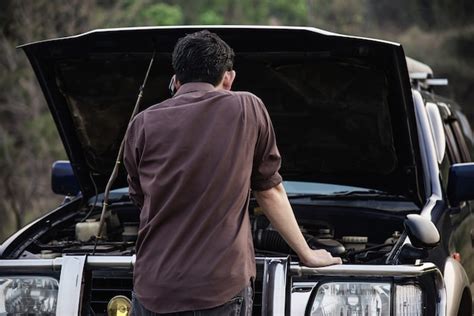 Free Photo Man Try To Fix A Car Engine Problem On A Local Road