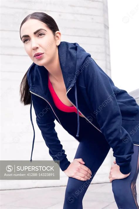 Woman In Sportswear Bending Forwards Superstock