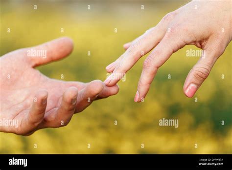 Male And Female Hands Reaching Out To Each Other Copying Creation Of Adam Sign Natural Sunset
