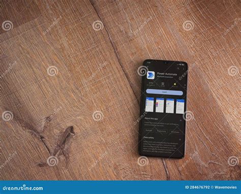 Power Automate App Play Store Page On Smartphone On Wooden Background