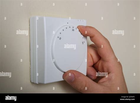 Turning Down The Central Heating Thermostat To Save Energy And Reduce
