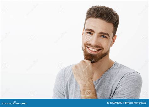 Successful And Happy Self Assured Male Entrepreneur Rubbing Beard