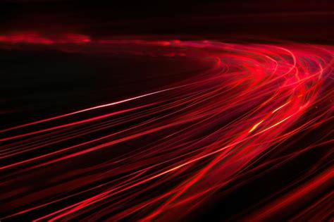 Premium Photo Abstract Red Light Trails In The Dark Background