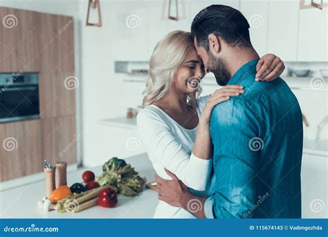 Happy Couple Hugging In Kitchen Romantic Relationship Stock Image