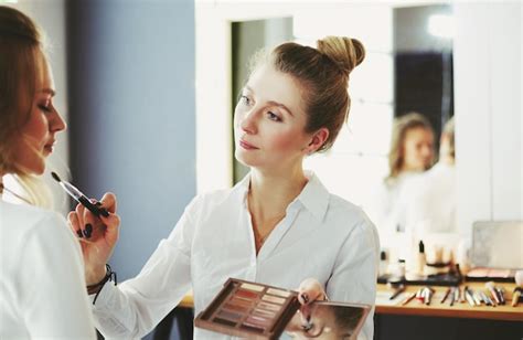 Premium Photo Make Up Artist Doing Professional Make Up Of Young Woman