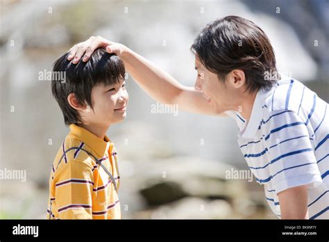 Father Stroking Son S Head Stock Photo Alamy