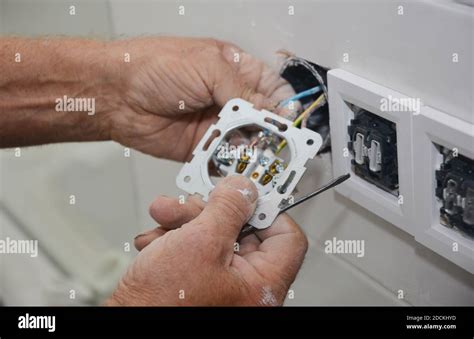 An Electrician Is Installing Adding New Electrical Socket Connecting Power Socket Outlet