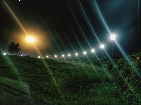 Premium Photo Illuminated Field Against Sky At Night