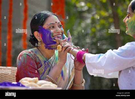 Daughter In Law Applying Colour On Mother In Laws Face On Holi Stock