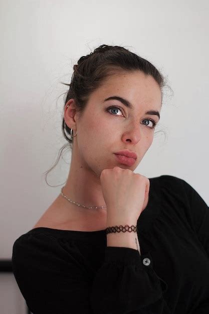 Premium Photo Portrait Of Young Woman Against Wall