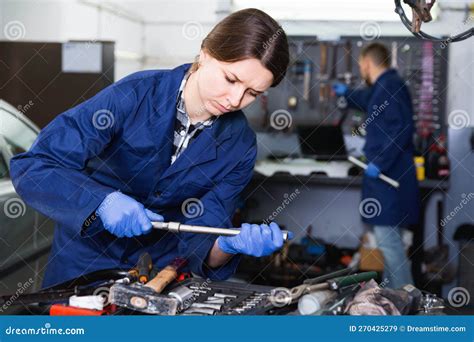 Young Woman Master Is Choosing Instruments For Work In Workshop Stock
