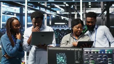 Portrait Of Smiling Data Center Specialists Collaborating In Server