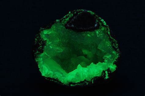 A Close Up Of A Piece Of Green Material On A Black Surface With Light