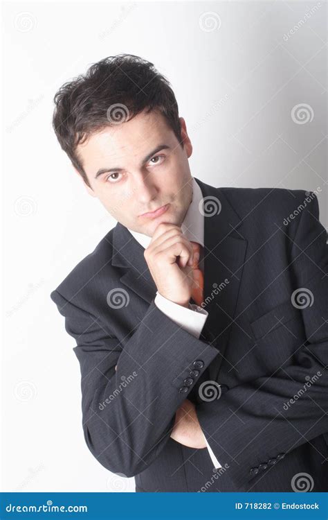 Thinking White Business Man In Suit With Hand On Chin Stock Photo