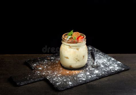Tiramisu In A Glass Jar Decorated With Mint And Strawberries Stock