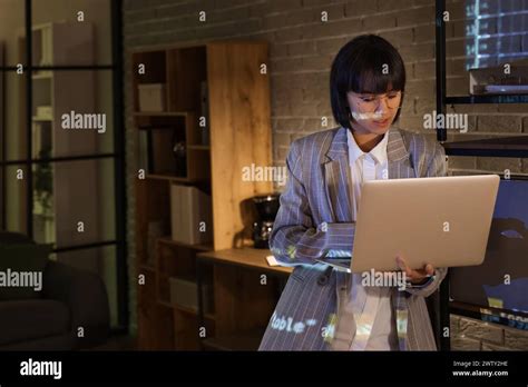 Female Programmer Working With Laptop In Office At Night Stock Photo Alamy
