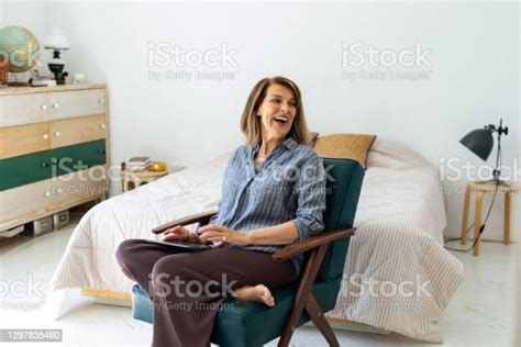 집에서 일하기 집에서 디지털 태블릿을 사용하는 아름다운 미소 짓는 노인 여성 65 69세에 대한 스톡 사진 및 기타 이미지