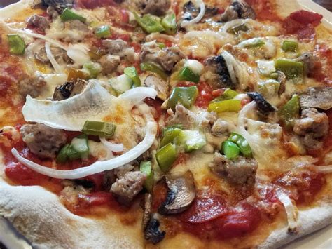 Pizza With Pepperoni Sausage Onion And Green Peppers Stock Image