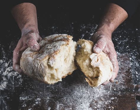 Premium Photo Broken White Bread In Male Hands