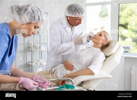 Elderly Woman Getting Procedure Of Injection Contouring And For Facial
