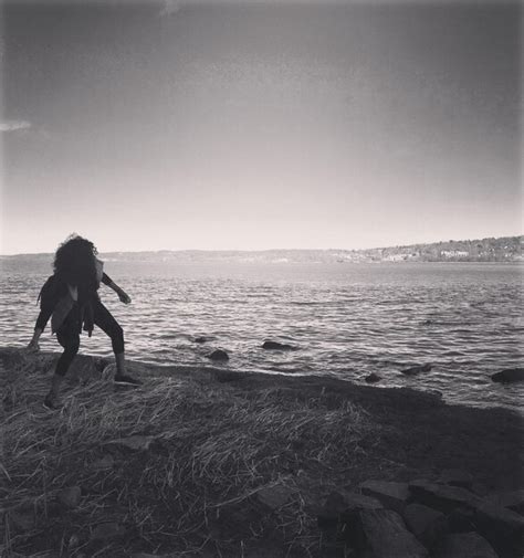 Premium Photo Woman Throwing Stone In Sea Against Sky