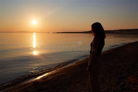 A Pretty Girl Enjoys The Sunset On A Sandy Beach Summer Travel