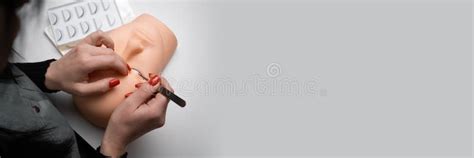 Person With A Mannequin Training Head Practicing Lash Extension