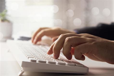 Side View Man Hands Typing Computer Keyboard White Laptop On Desk With