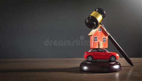 Judge Gavel With A House Model And Toy Car On The Wooden Table Stock