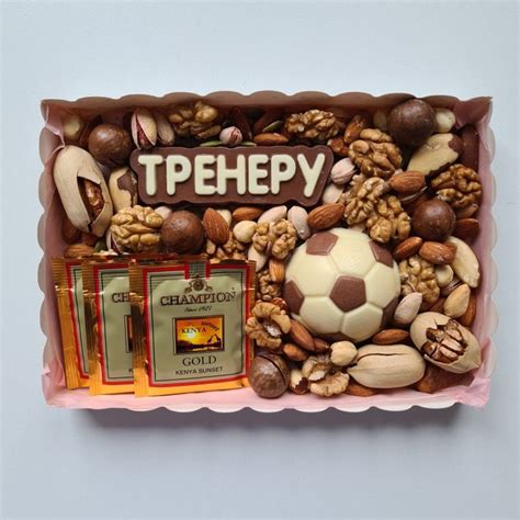 A Box Filled With Nuts And Chocolates On Top Of A White Table Next To A