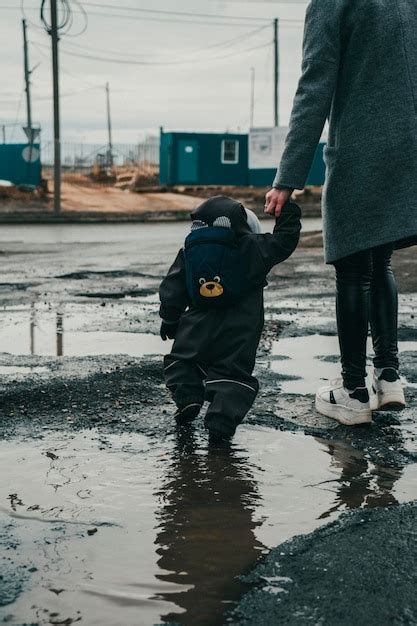 Low Section Of Man Standing In Puddle Premium Photo
