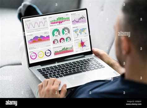 Analytics Dashboard And Information Technology On Laptop Stock Photo