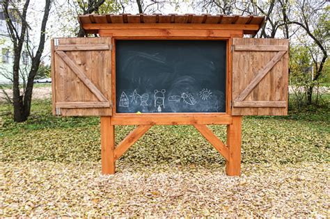 Empty Outdoor Class Room With Classic Chalk Board With Trees As