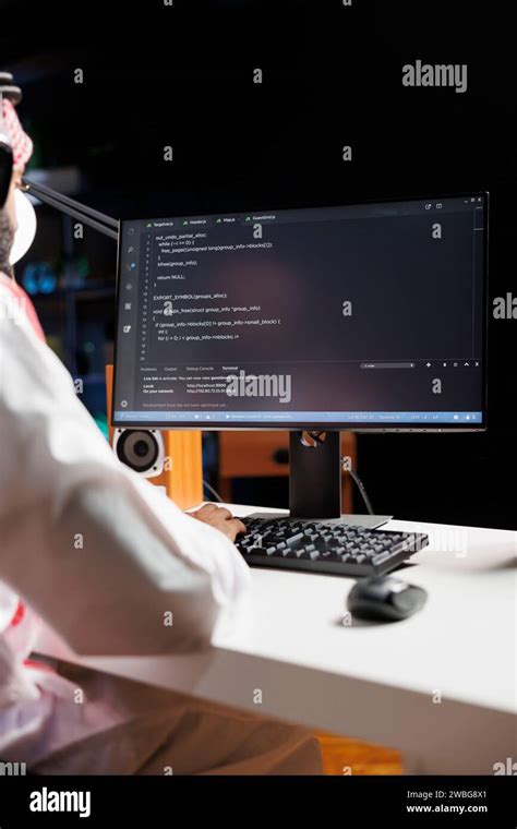 Muslim Guy Sits At Desk And Codes On Computer Demonstrating The App