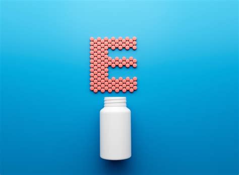 Premium Photo 3d Empty White Pill Bottle With E Text Made Of Rounded Vitamin E Tablets 3d