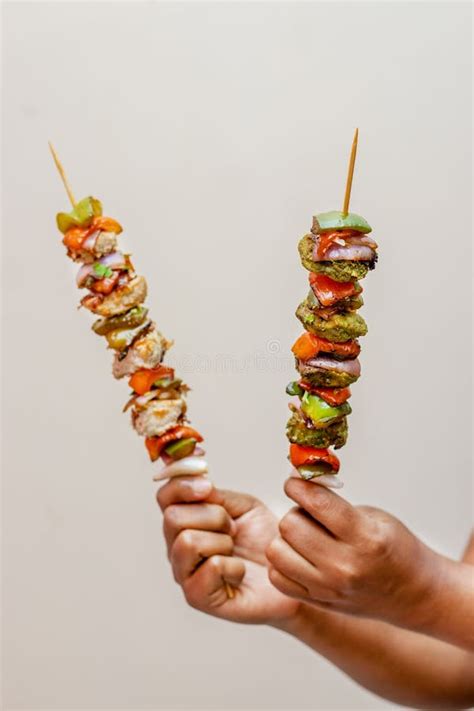 Chicken Hariyali Tikka Kabab With Reshmi Kabab Holding By Hands Stock