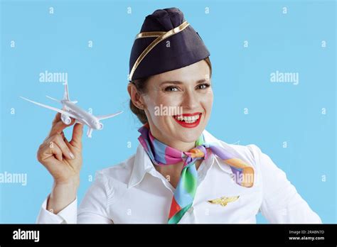Happy Modern Female Air Hostess On Blue Background In Uniform With A