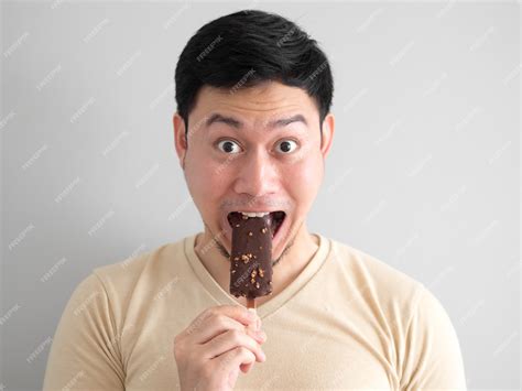 Premium Photo Funny Face Asian Man Eat Chocolate Vanilla Ice Pop